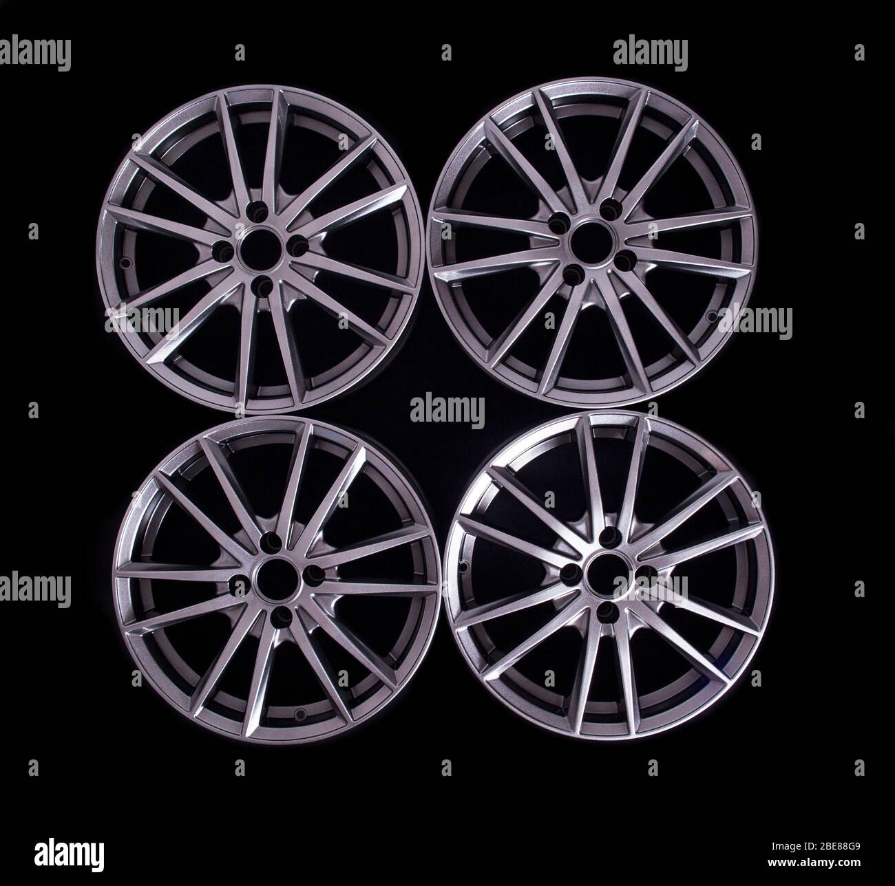 Modern automotive alloy wheel made of aluminum on a black background ...