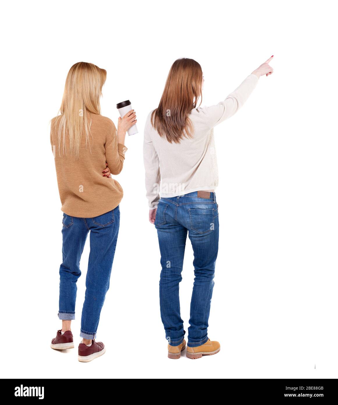 Back view of two pointing girl in sweater. Rear view people collection ...