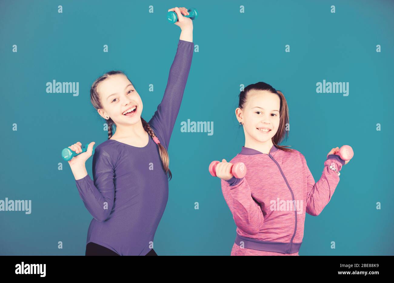 Girls exercising with dumbbells. Beginner dumbbells exercises. Children ...