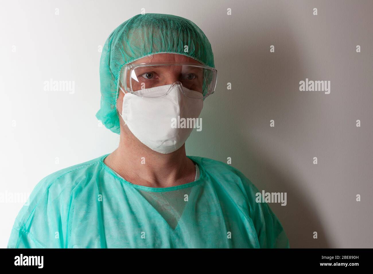 Male nurse, with plastic protective eyeglasses and respirator ffp2, cap ...