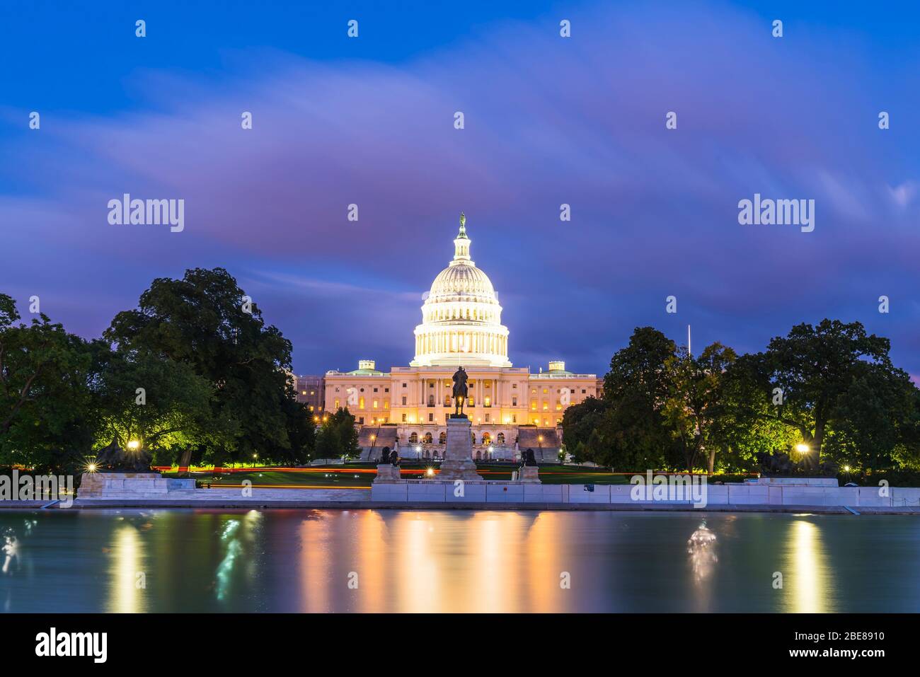 The United States Capitol building at sunset wirh reflection in water ...