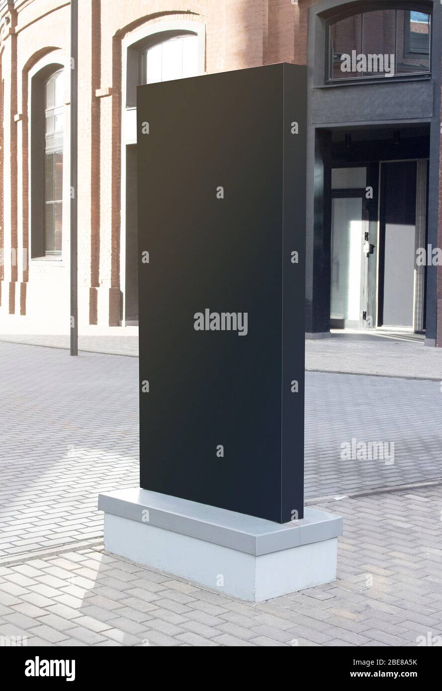 Blank black vertical pylon stand mockup brick building, side view Stock ...