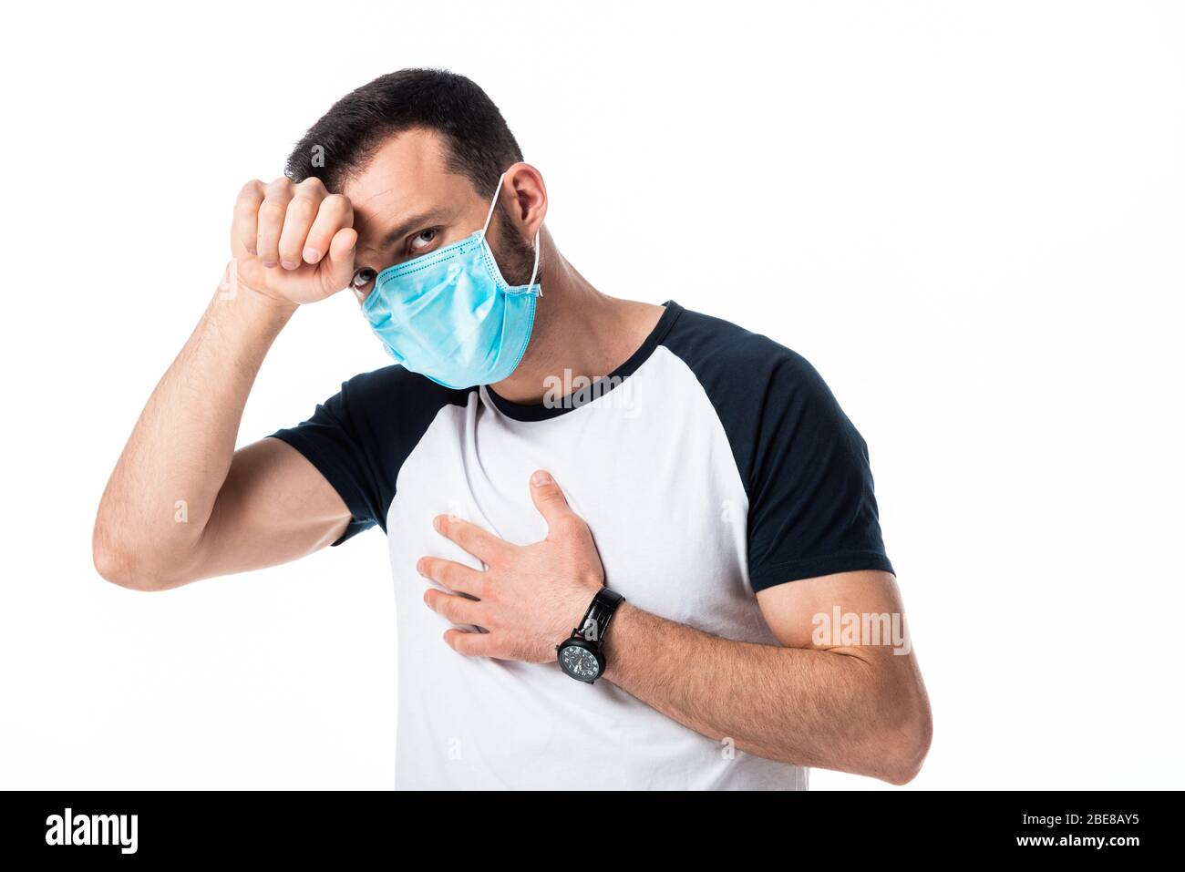 sick man in medical mask touching forehead isolated on white Stock ...