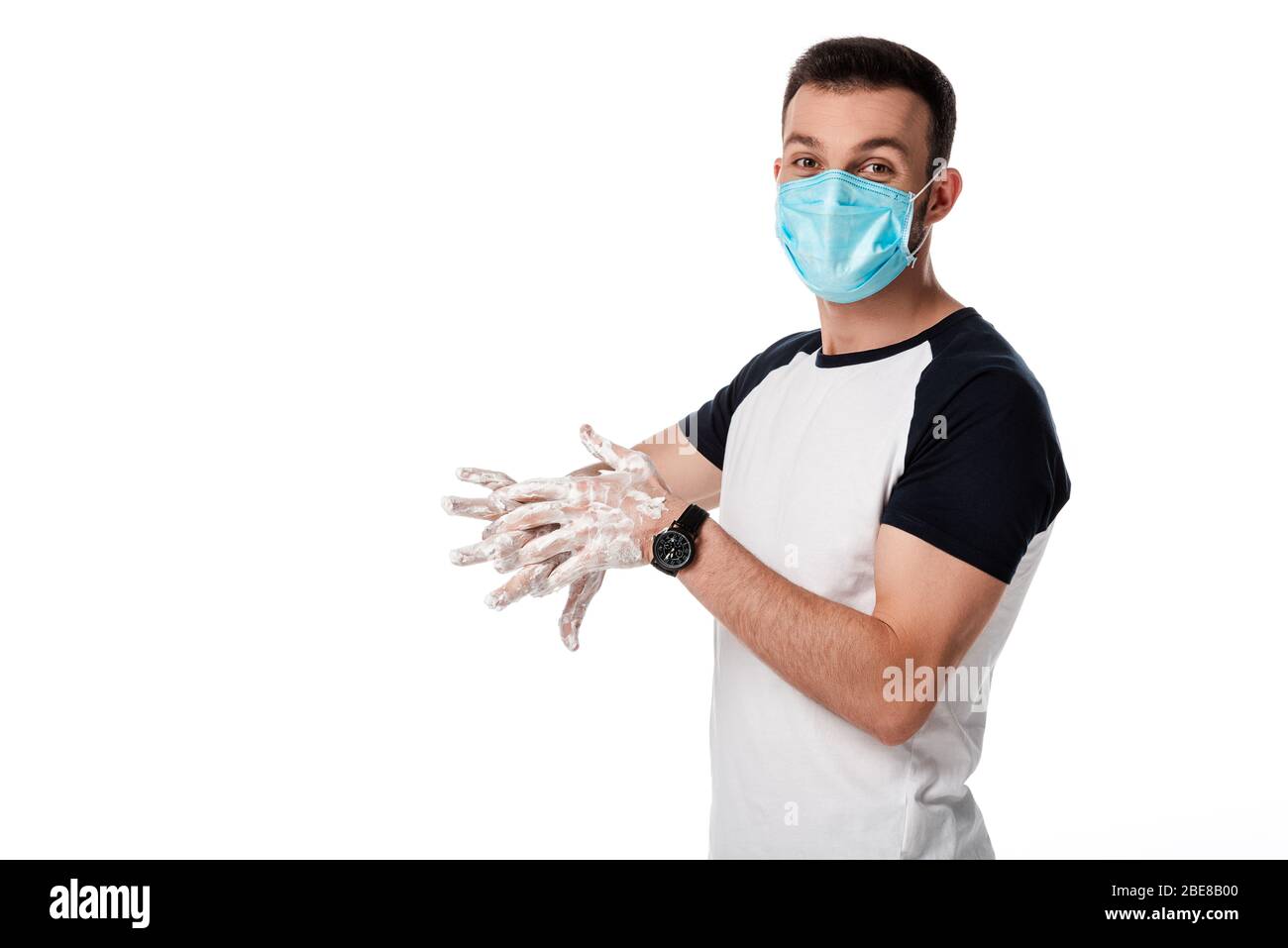 man in medical mask washing hands and standing isolated on white Stock ...