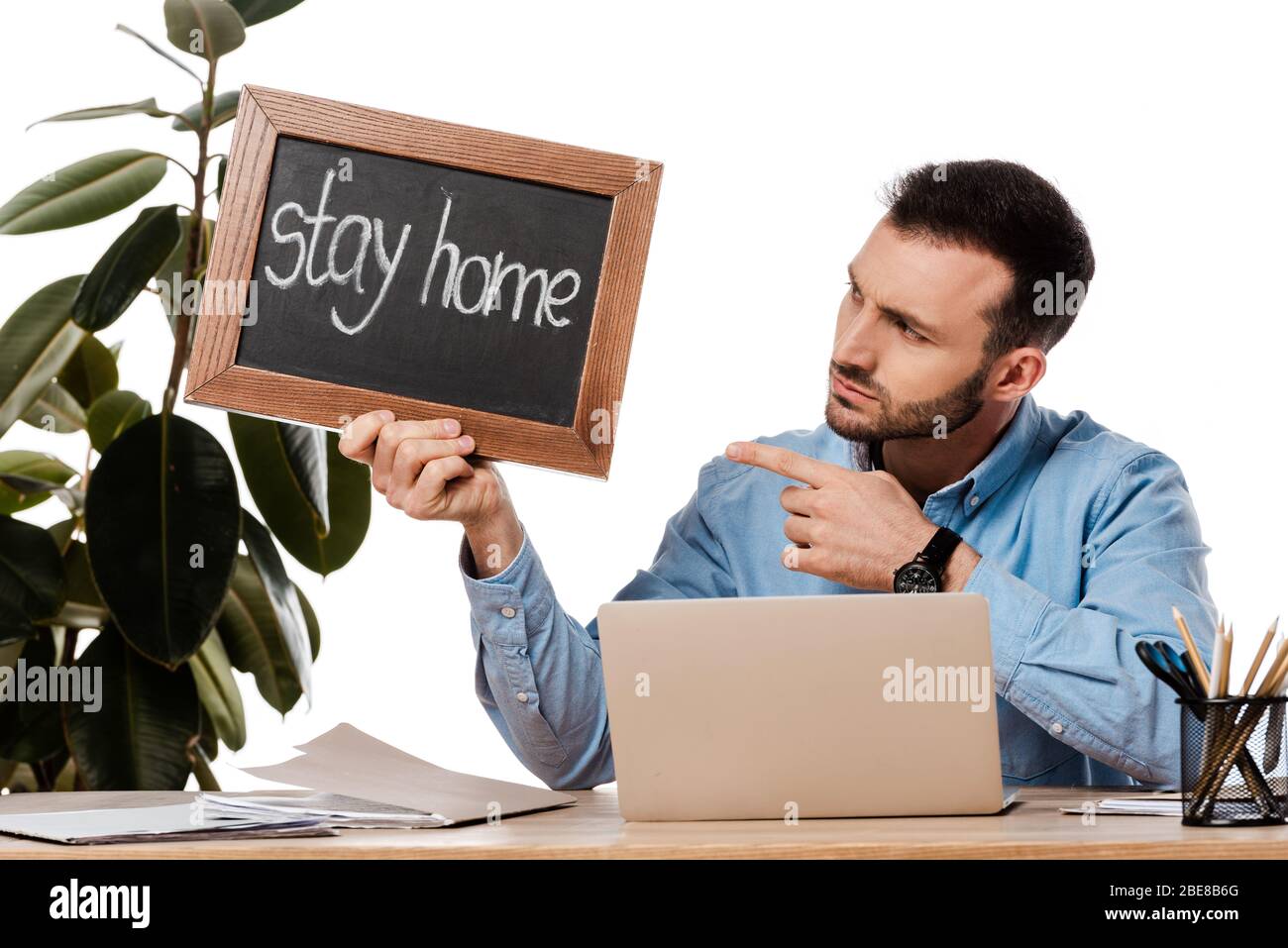 handsome freelancer pointing with finger at chalk board with stay home ...