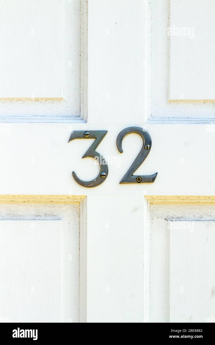 House number 32 on a white wooden front door Stock Photo - Alamy