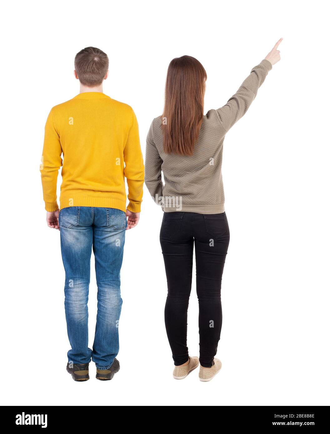 Back view of couple in sweater pointing. Rear view people collection ...