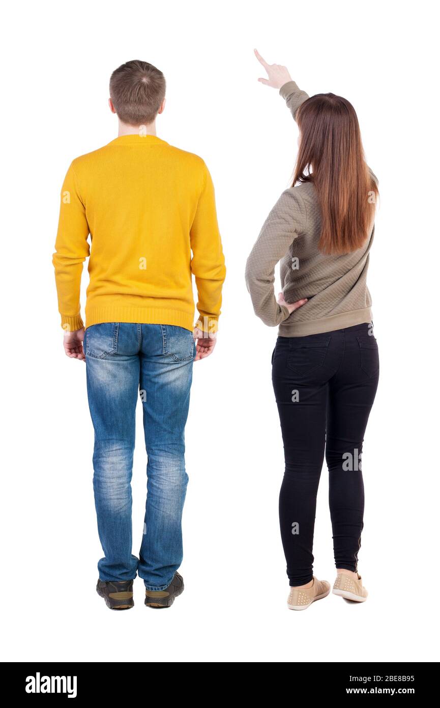 Back view of couple in sweater pointing. Rear view people collection ...