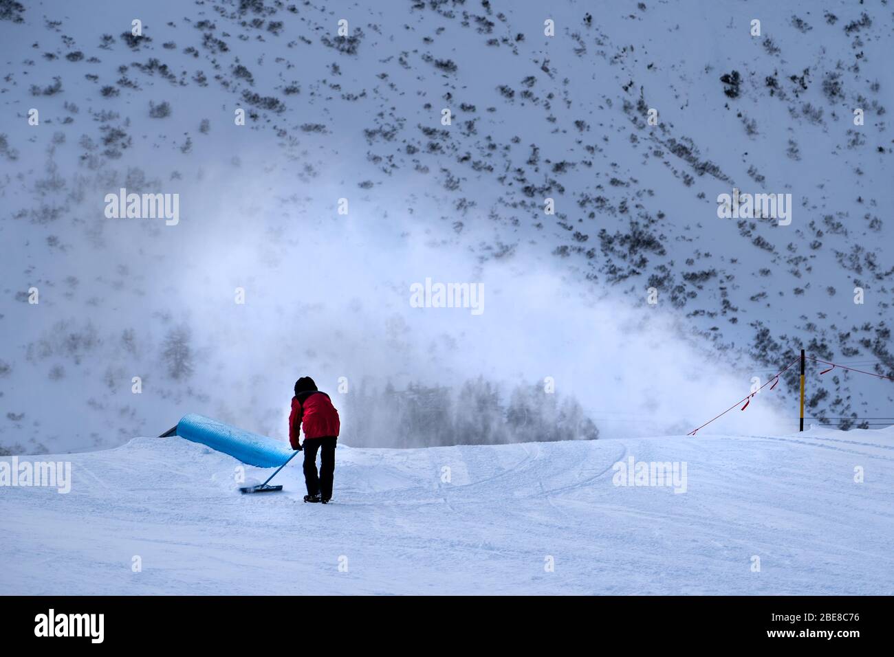 A Snowpark Shaper shaping a tube with a shapetool in front of snow ...