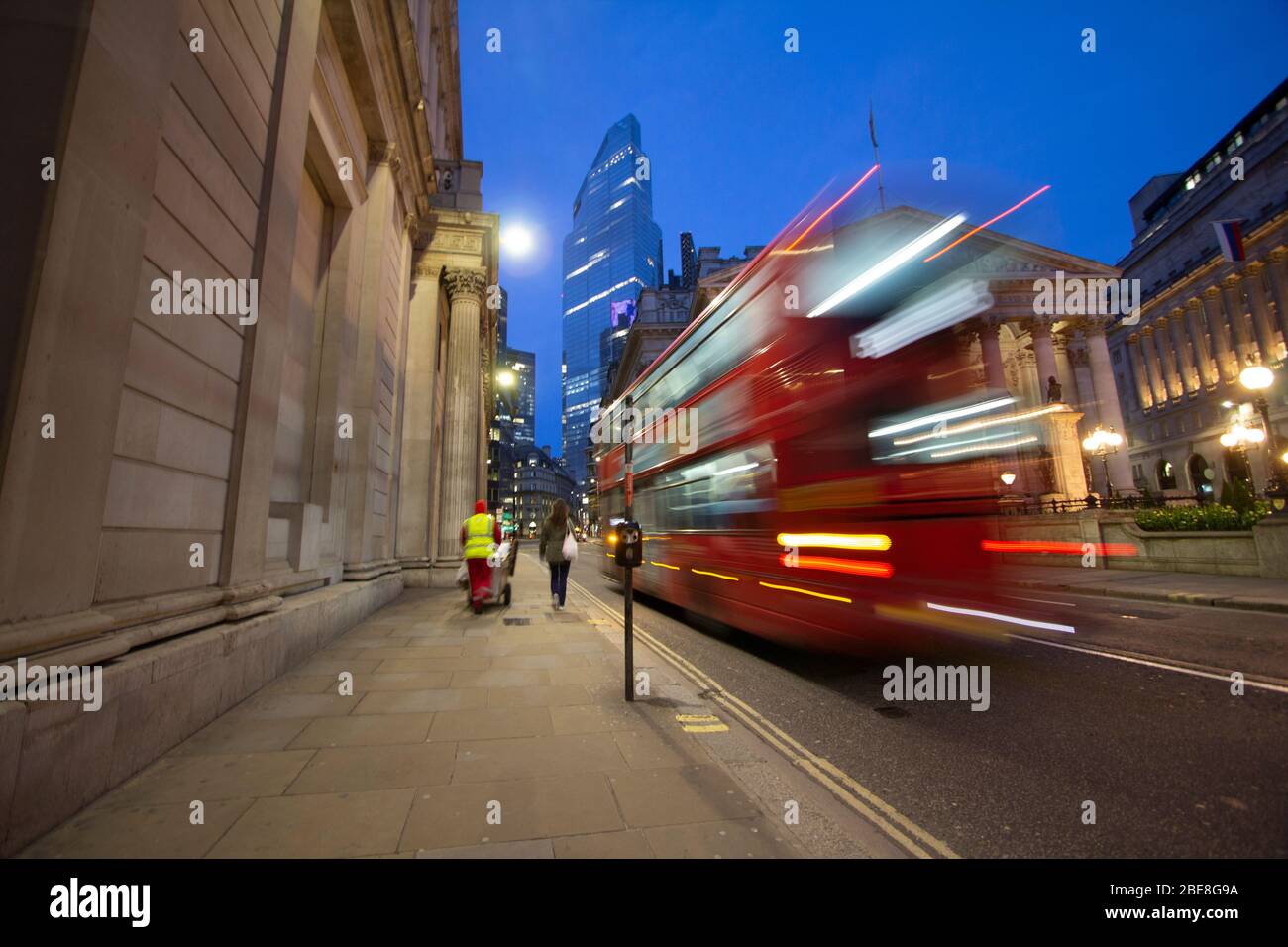 London bus speeding past the Bank of England with street cleaner and ...
