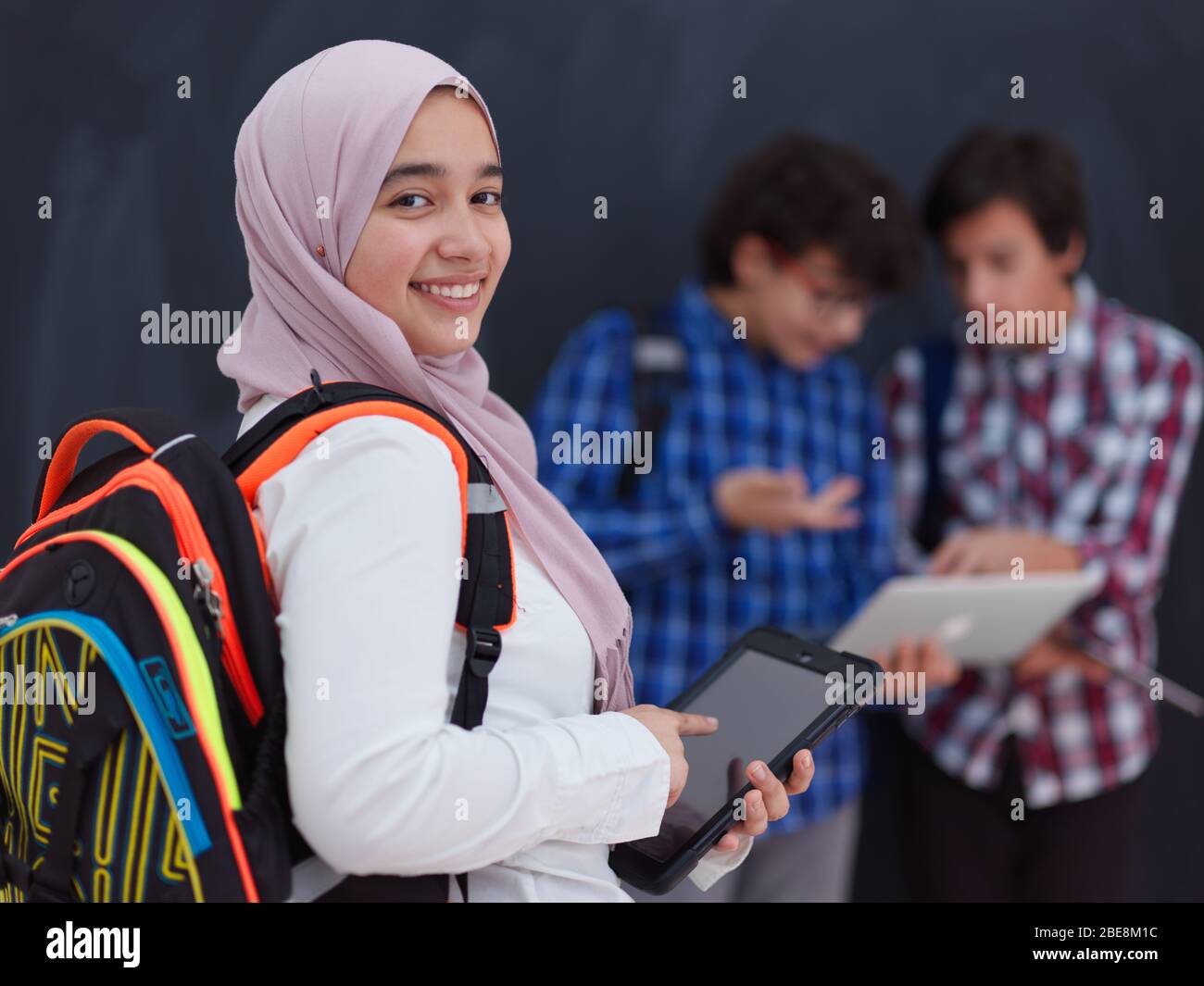 Arabic teenagers team, students group working together on laptop and ...