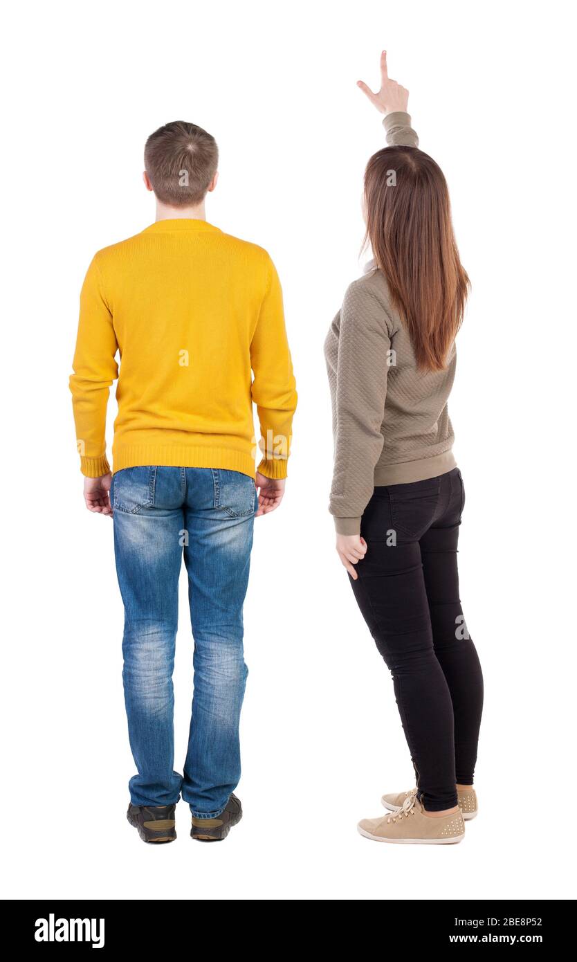 Back view of couple in sweater pointing. Rear view people collection ...