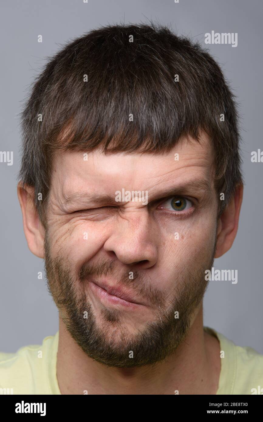 Close-up portrait of a man of European appearance who squeezed his left ...