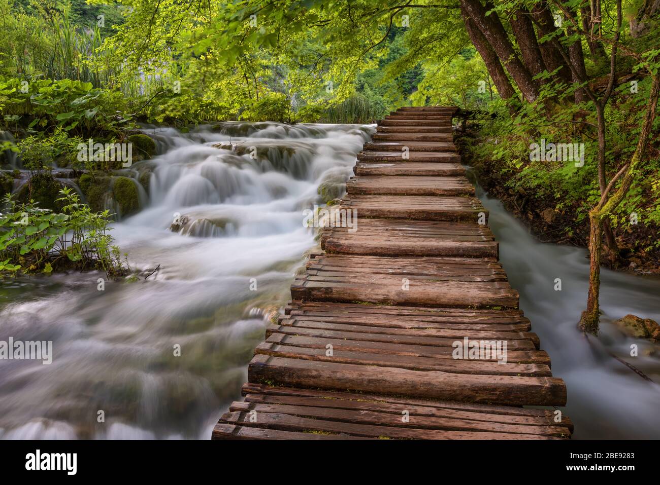 Beautiful view of waterfalls with turquoise water and wooden pathway ...