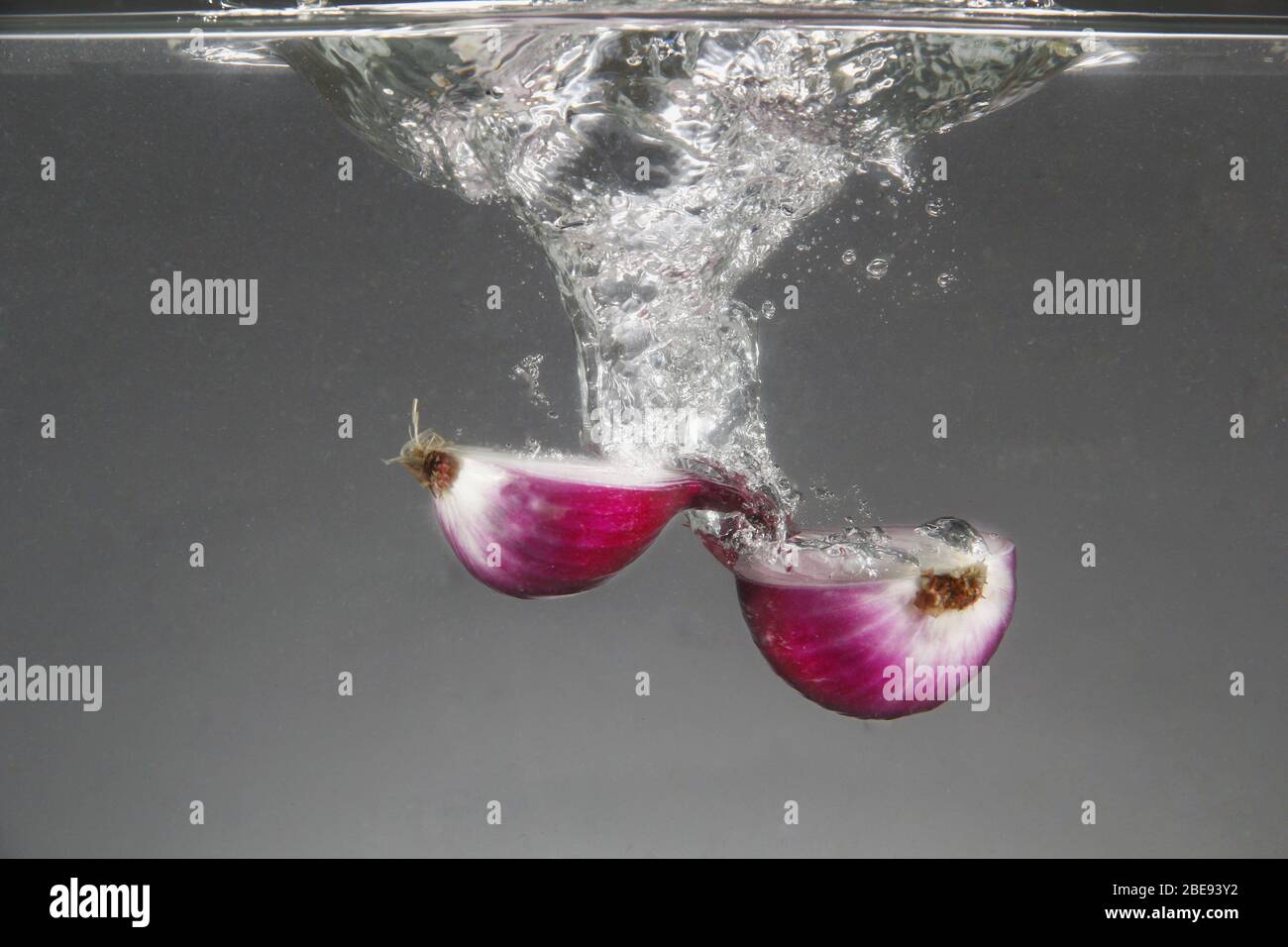 Photo of fresh red onion dropped in water Stock Photo - Alamy
