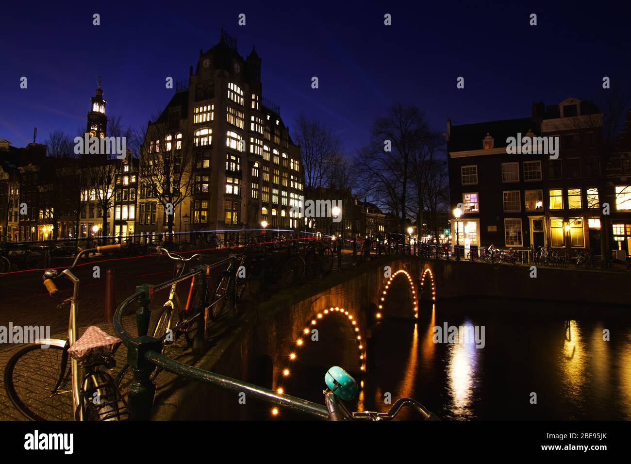 illuminated arch bridge in Amsterdam by night, long exposure shot Stock ...