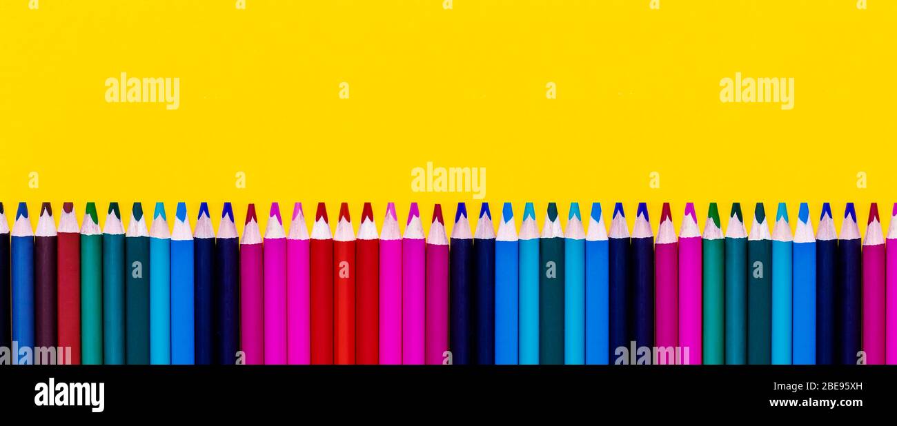 Banner with multicolored wooden pencils on yellow background. Large ...