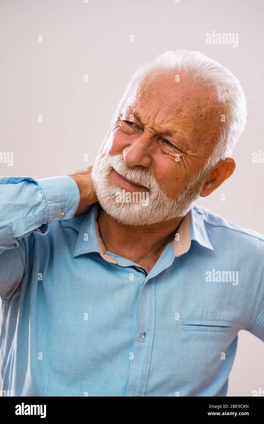 Old businessman having neck pain hi-res stock photography and images ...