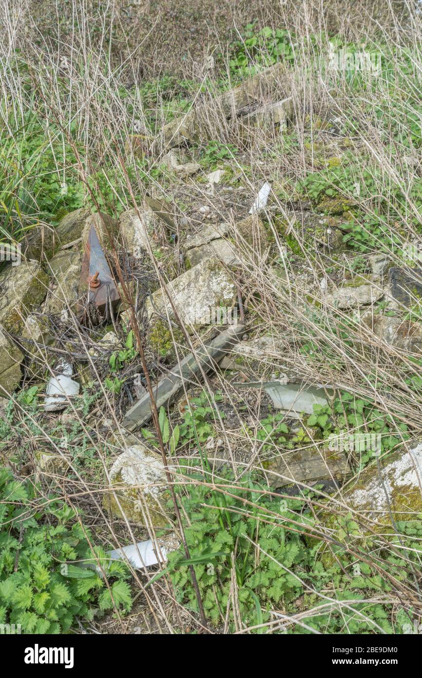 Pile of fly-tipped building rubble dumped in a rural setting Stock ...