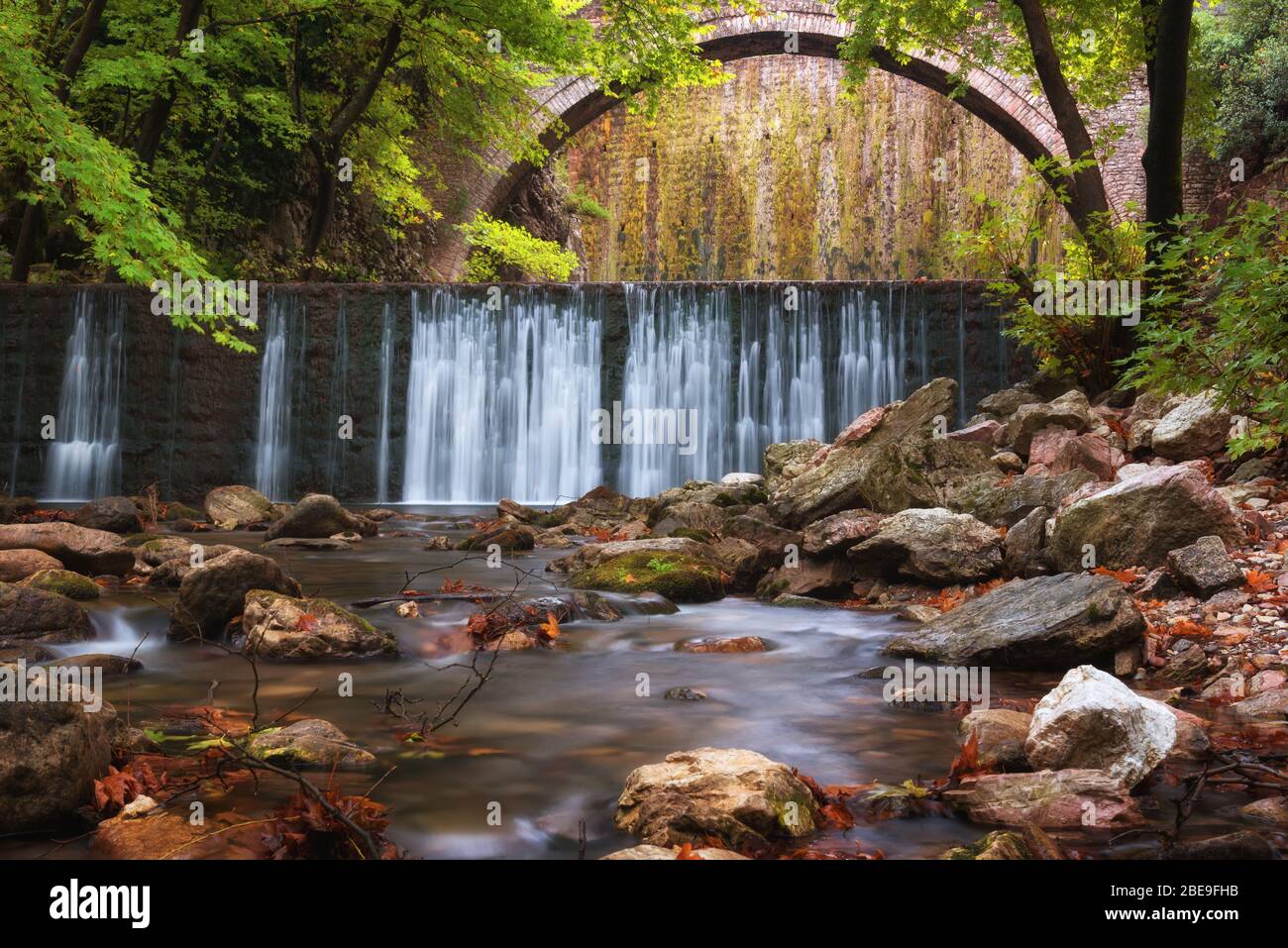 Paleokarya old stone arched bridge, between two waterfalls. Trikala ...