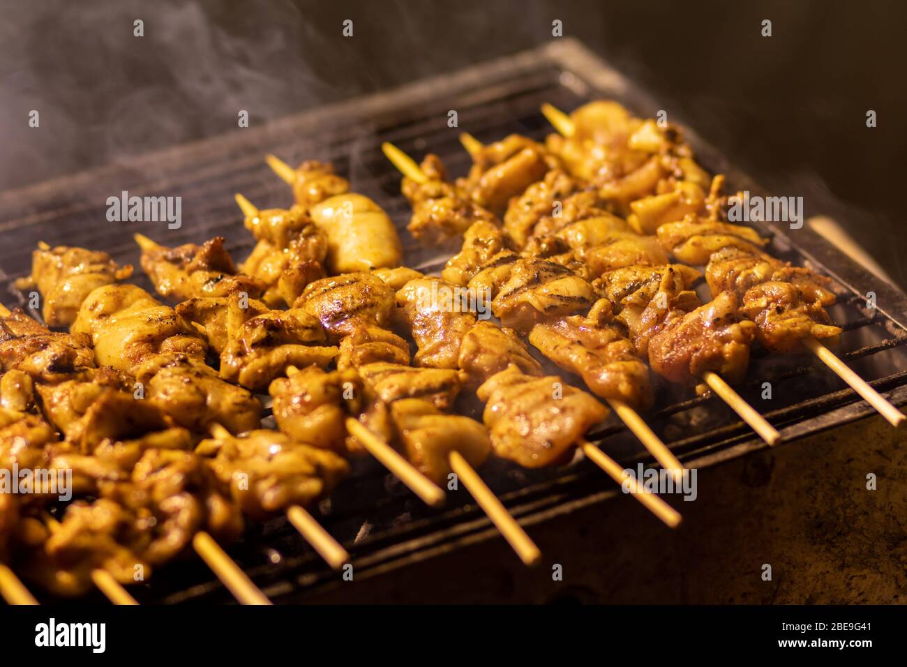 Chicken chunks skewers, grill, barbecue. On a metal bbq. In the ...