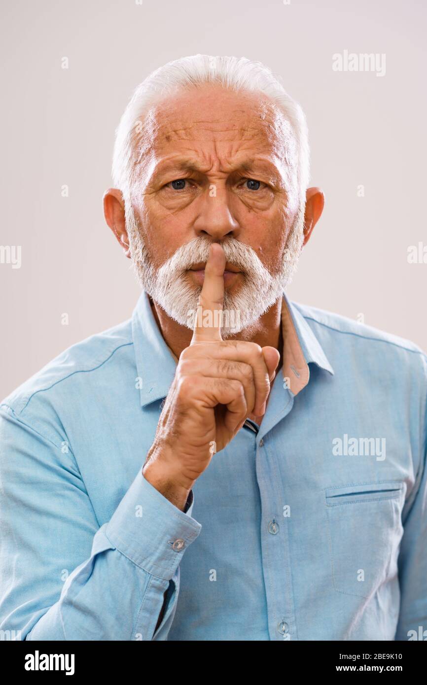 Portrait of angry senior man who wants silence Stock Photo - Alamy