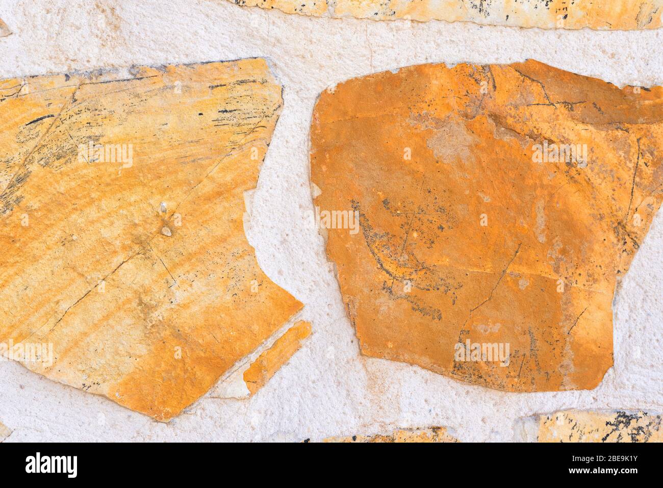 Yellow and white stone wall in a mosaic style. Texture background Stock ...