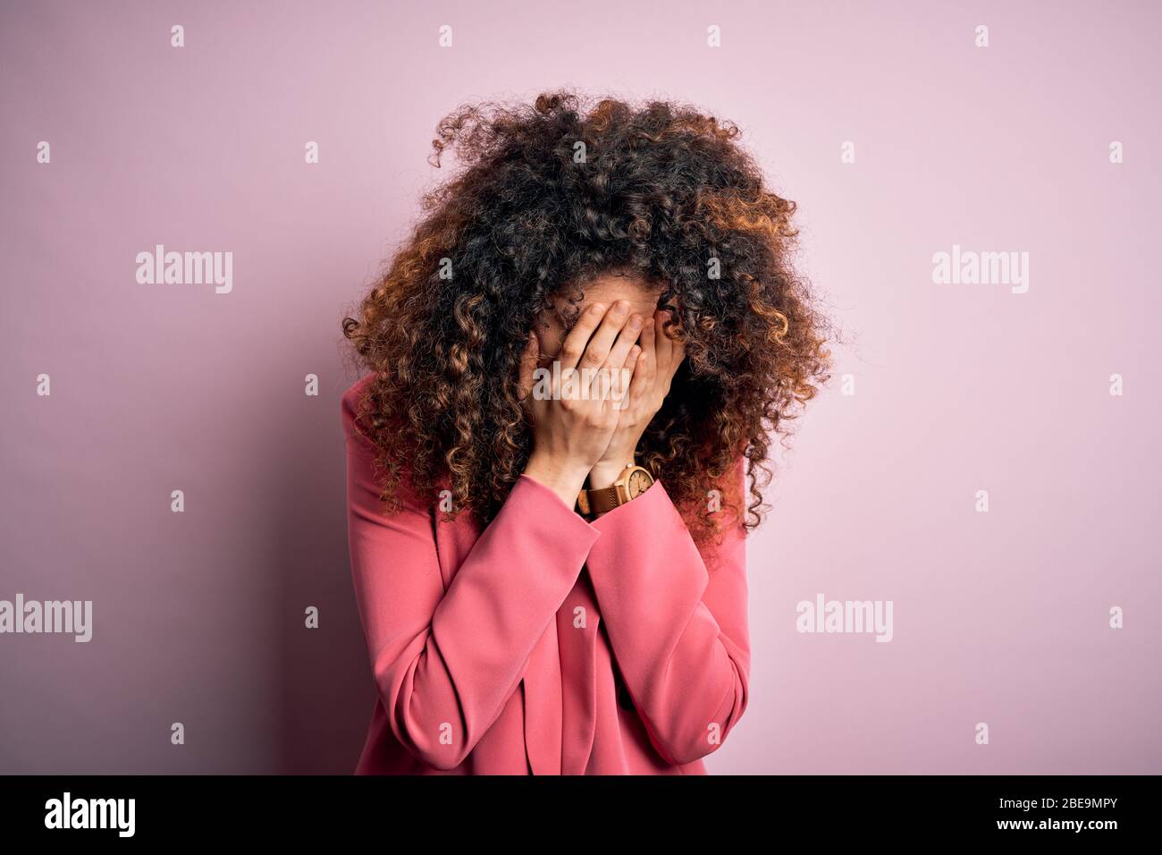 Young beautiful businesswoman with curly hair and piercing wearing ...