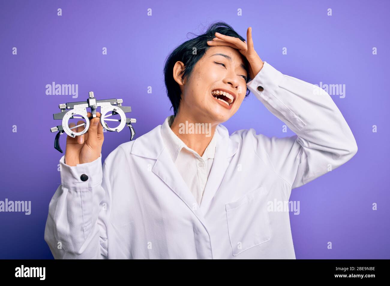 Beautiful asian optical girl wearing coat holding optometry glasses ...