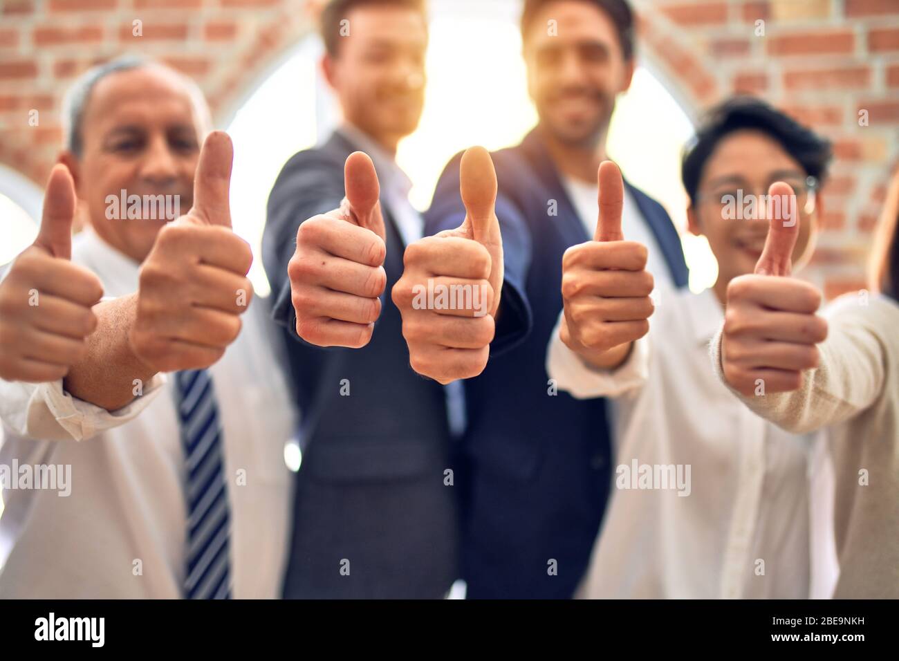 Group of business workers smiling happy. Standing with thumbs up at the ...