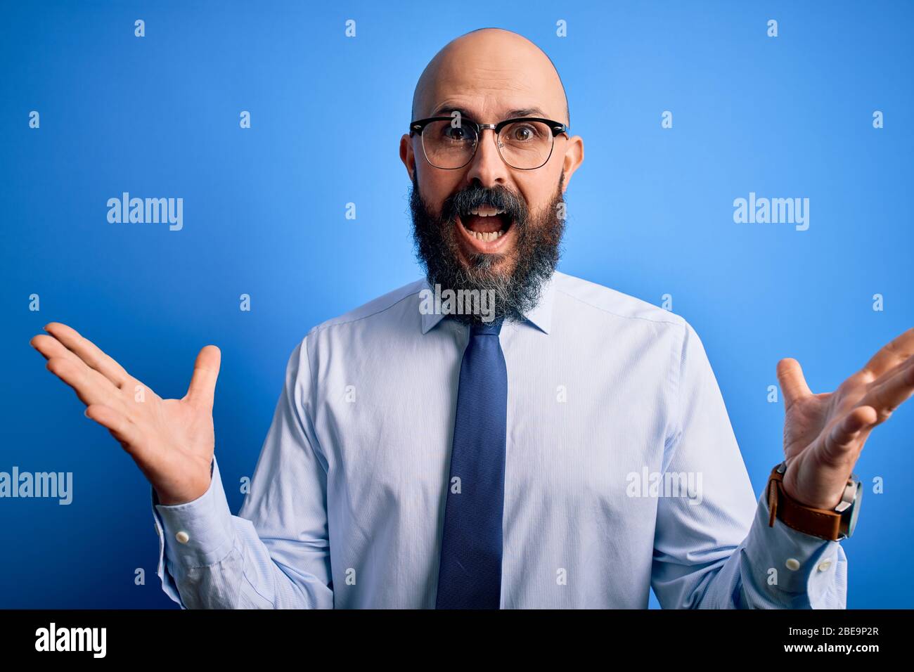 Handsome business bald man with beard wearing elegant tie and glasses ...