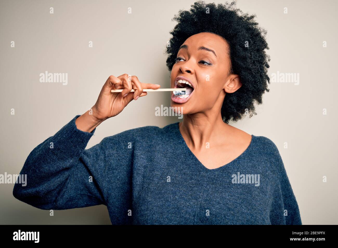 African american woman brushing her teeth using tooth brush and oral ...