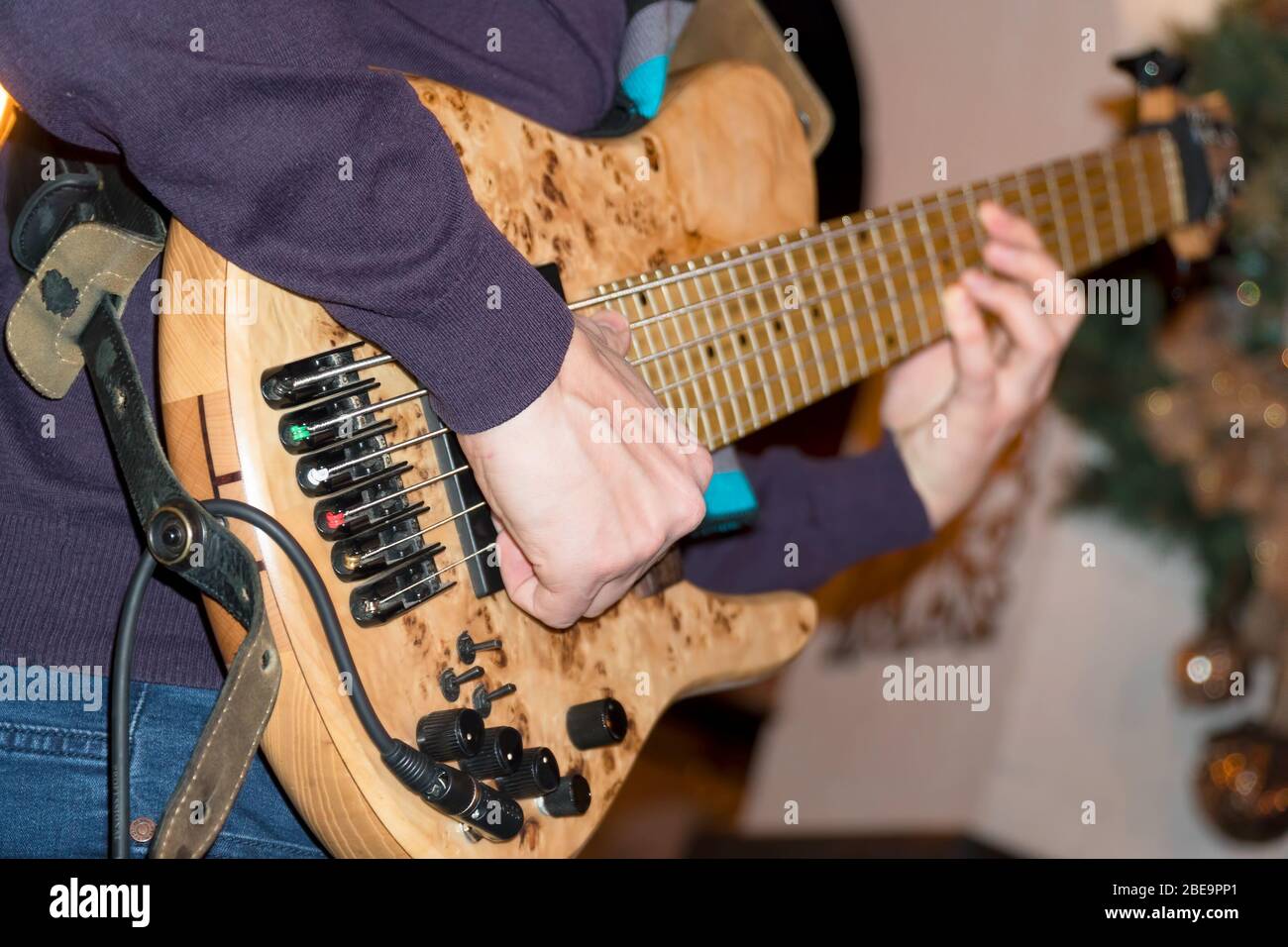 The bass player plays a five-string bass guitar close-up. Plays bass ...