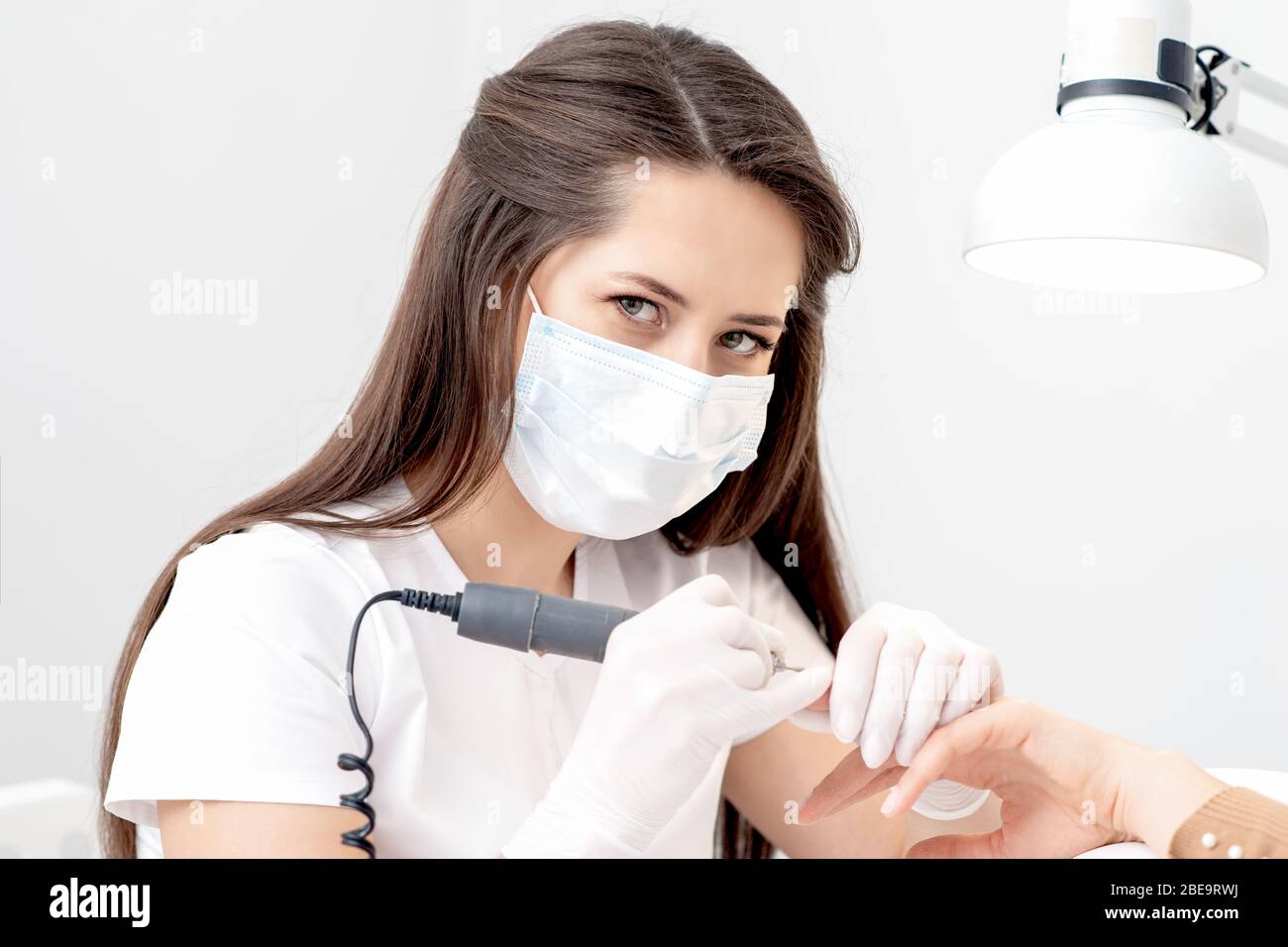 Manicure master making manicure with electric machine tool Stock Photo ...