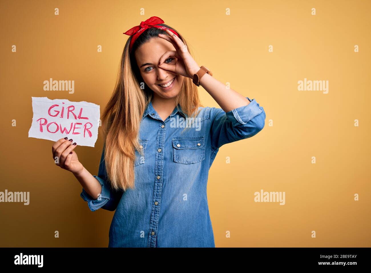 Blonde woman with blue eyes asking for girls rights holding banner with ...