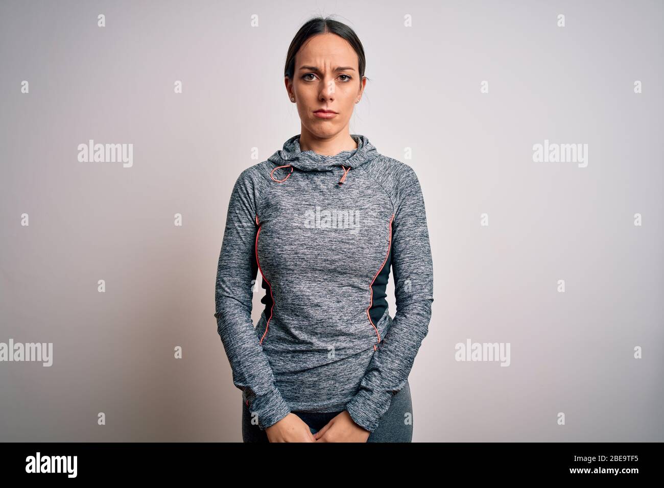 Young blonde fitness woman wearing sport workout clothes over isolated ...