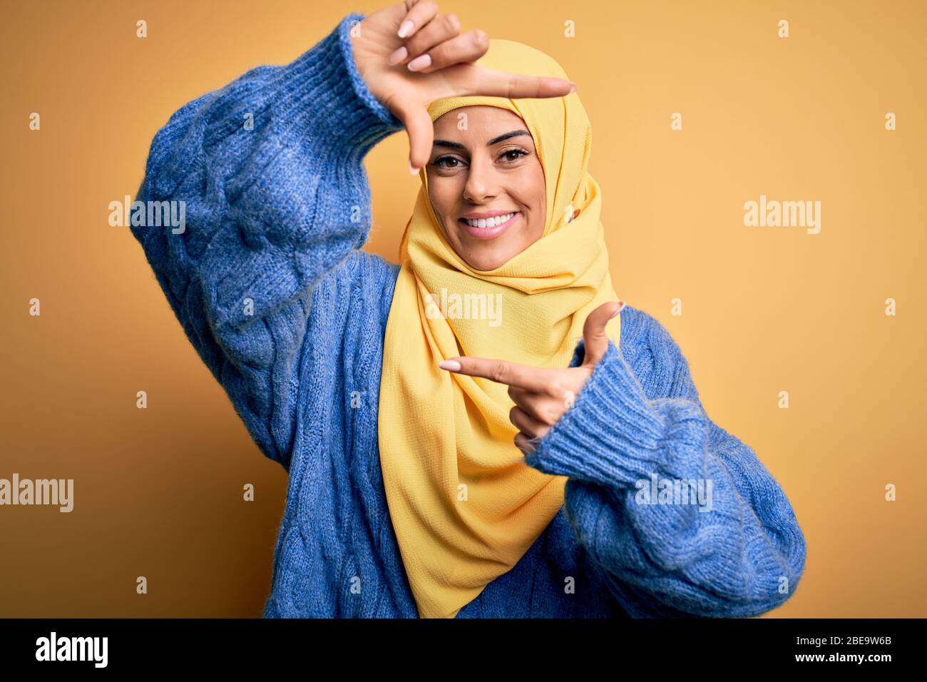 Young beautiful brunette muslim woman wearing arab hijab over isolated ...