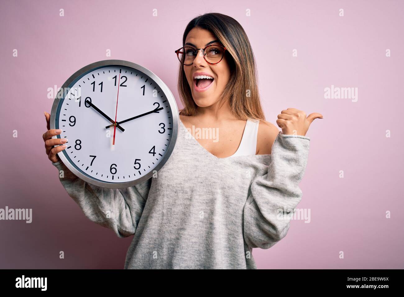 Young beautiful brunette woman wearing glasses doing countdown using ...