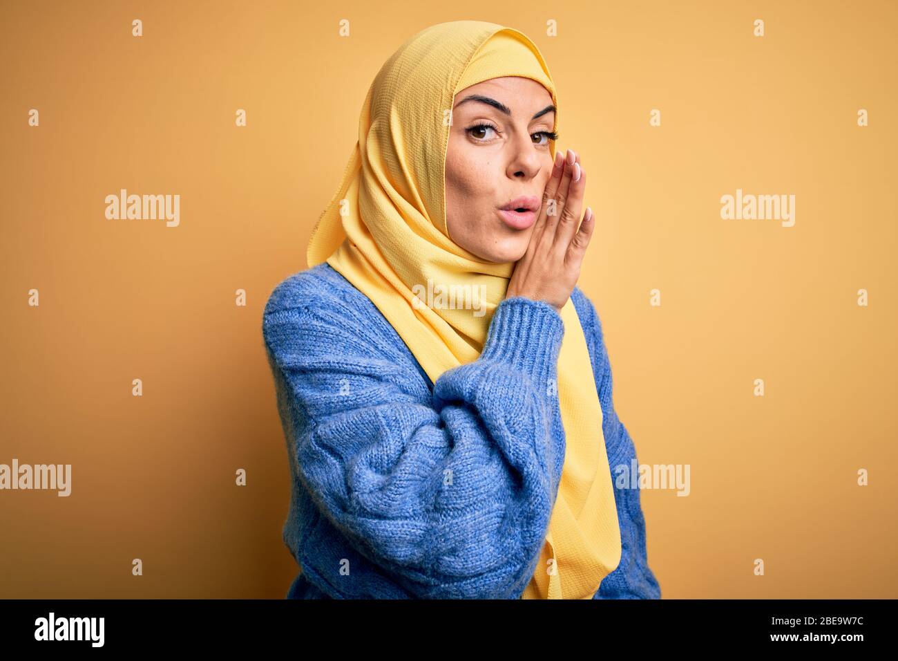 Young beautiful brunette muslim woman wearing arab hijab over isolated ...