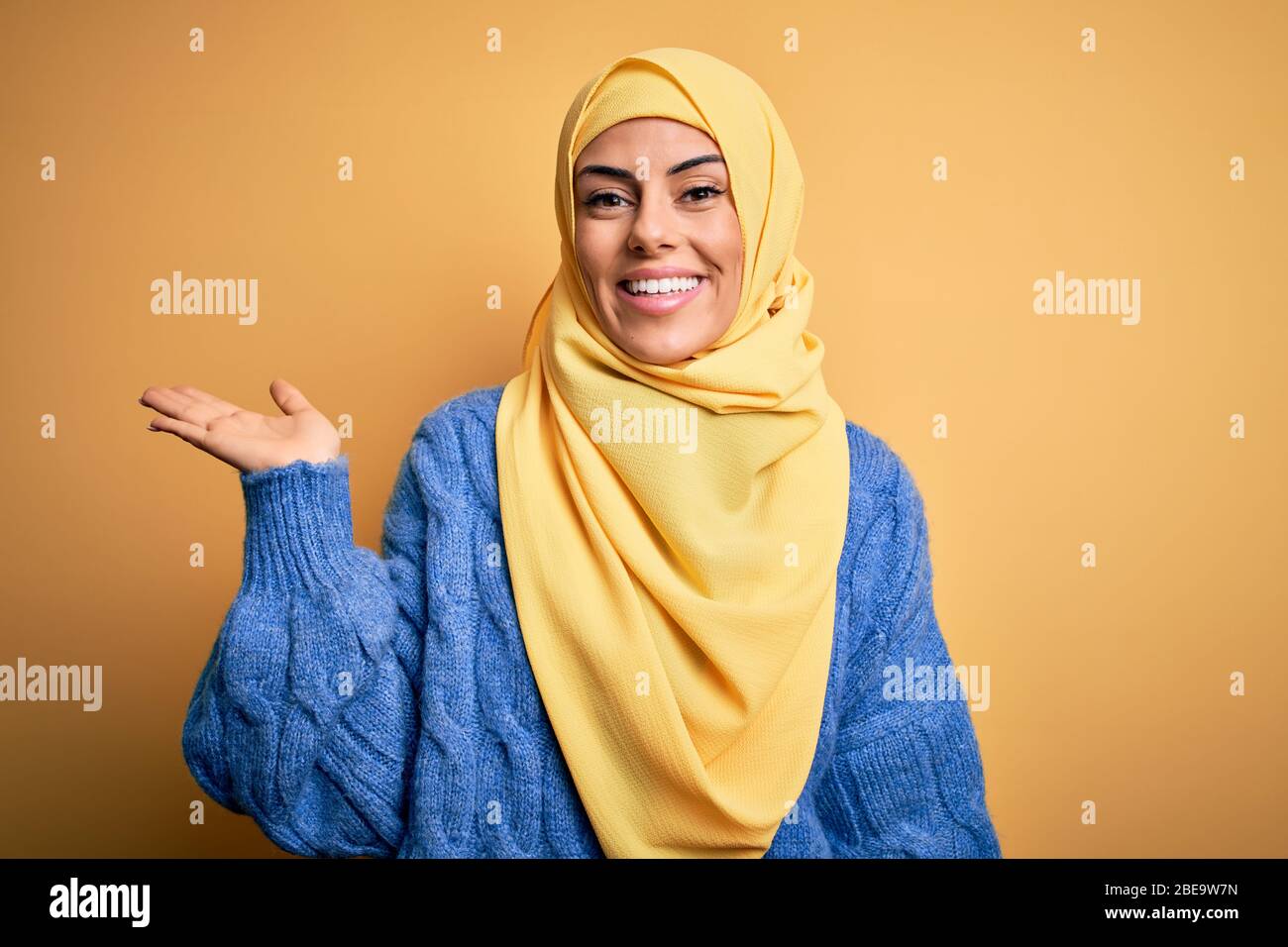 Young beautiful brunette muslim woman wearing arab hijab over isolated ...