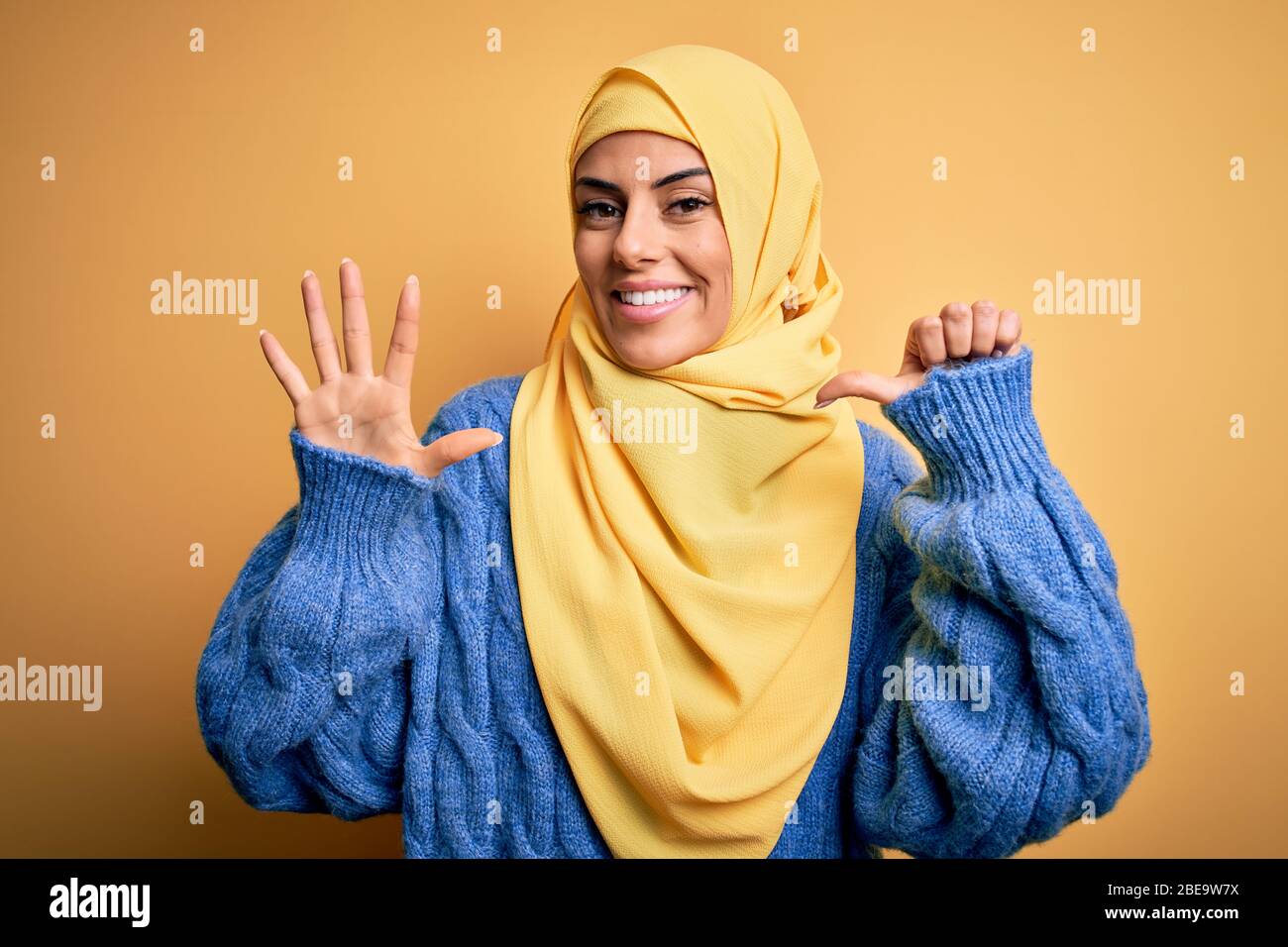 Young beautiful brunette muslim woman wearing arab hijab over isolated ...