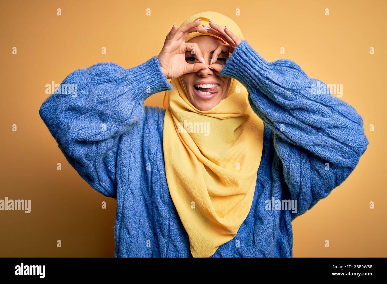 Young beautiful brunette muslim woman wearing arab hijab over isolated ...