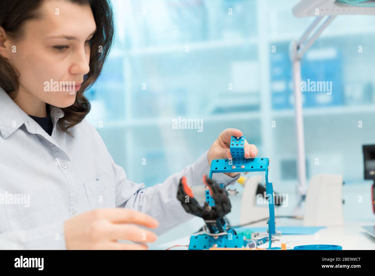 Student woman in robotics laboratory working on project mechatronics ...