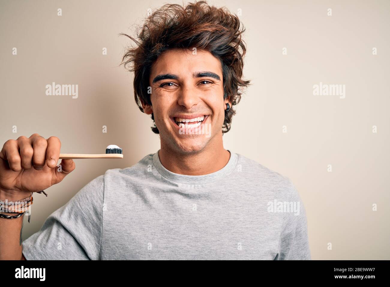 Young handsome man smiling happy. Standing with smile on face whasing ...