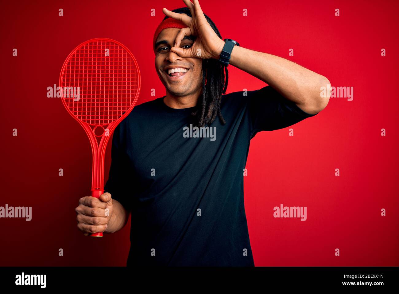 African american afro sportsman with dreadlocks holding tennis racket ...