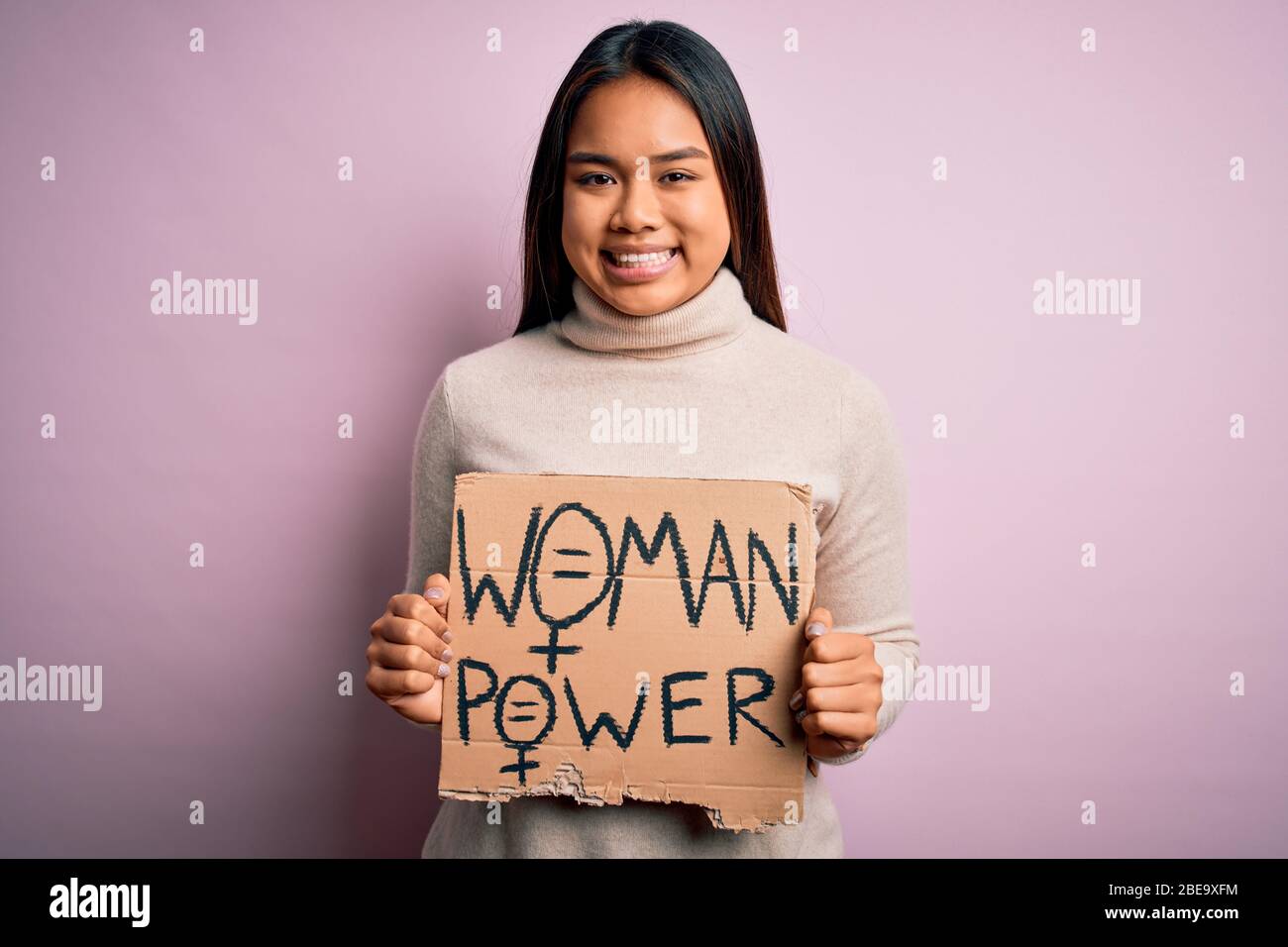 Young asian activist girl asking for women rights holding banner with ...