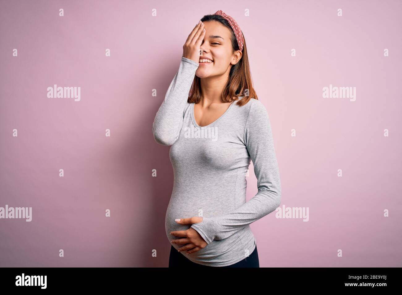 Young beautiful teenager girl pregnant expecting baby over isolated ...