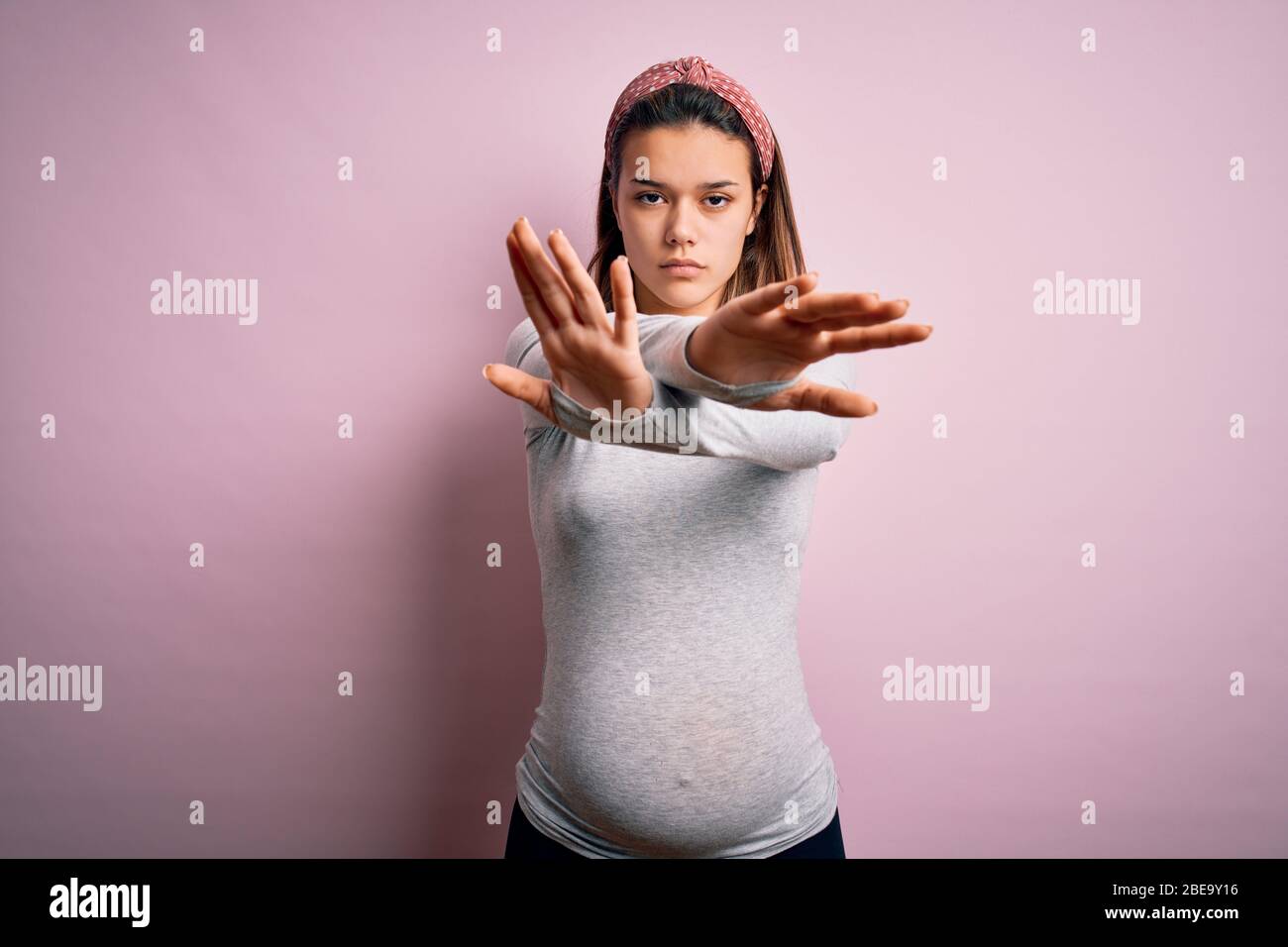 Young beautiful teenager girl pregnant expecting baby over isolated ...