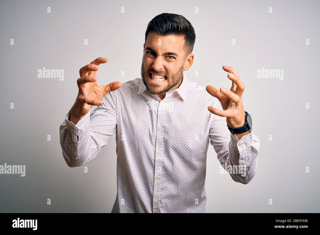 Young handsome man wearing elegant shirt standing over isolated white ...