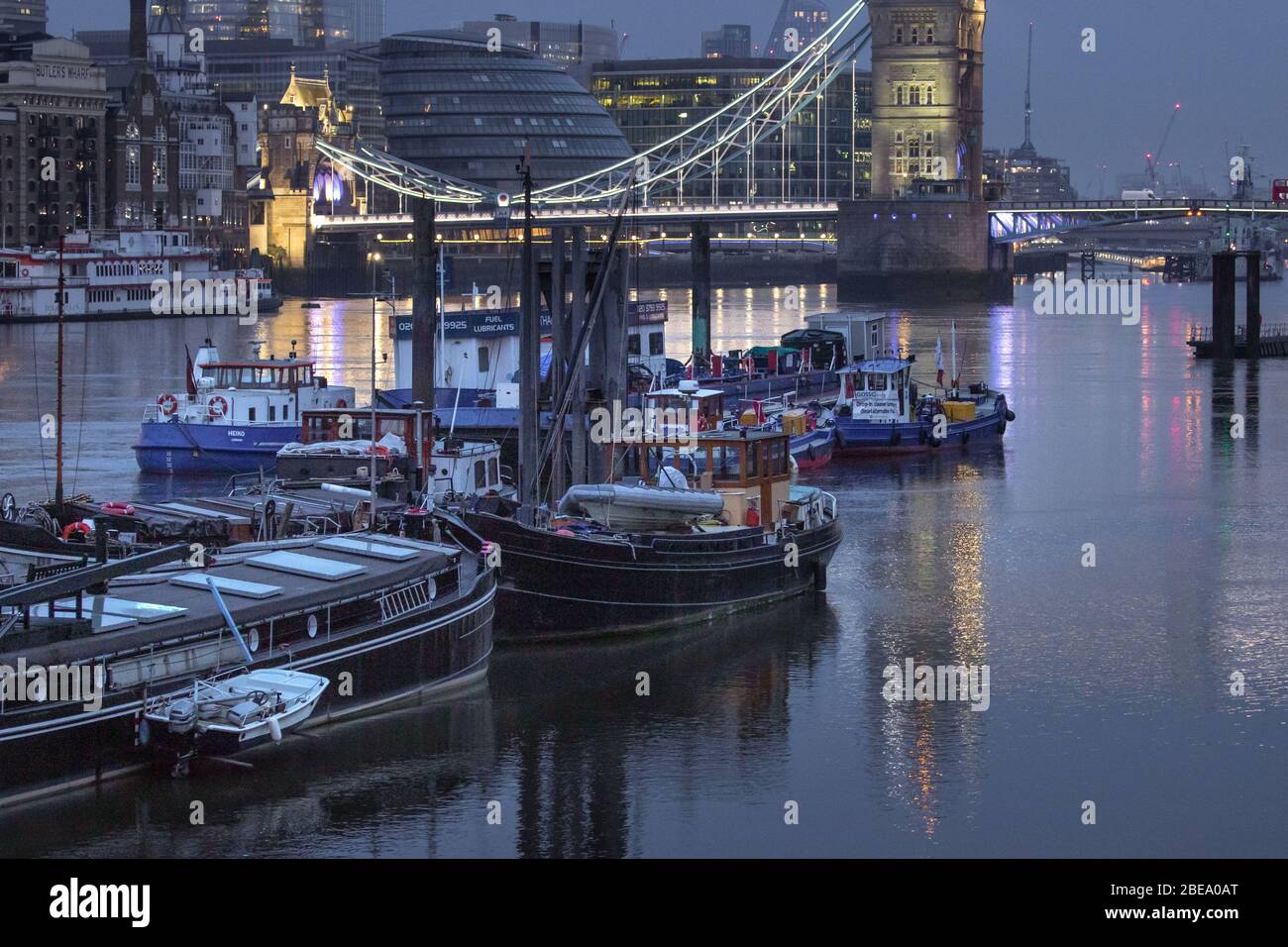 Boats in the Pool of London by Tower Bridge in the early morning light ...